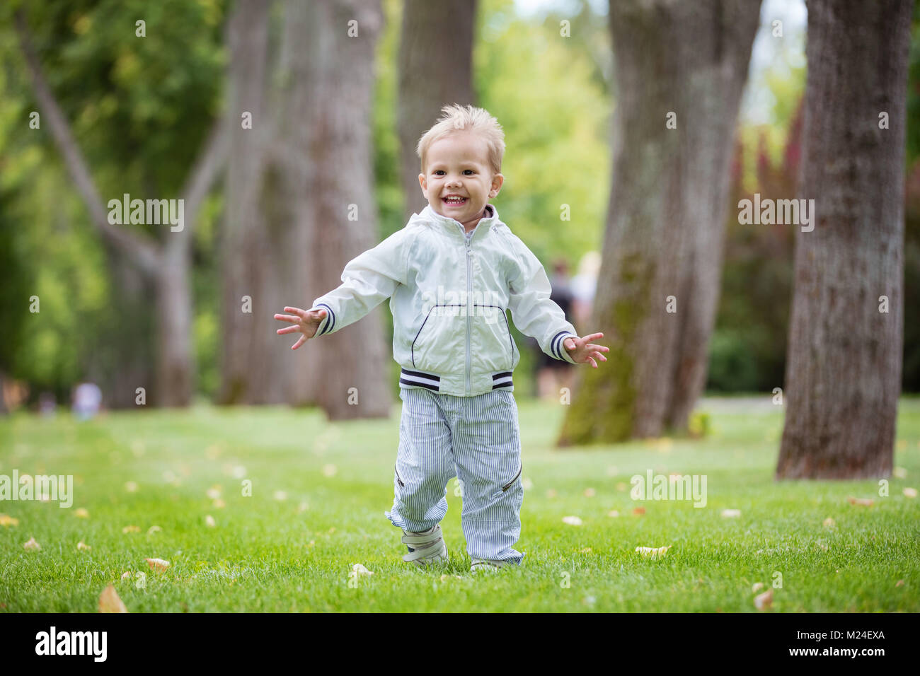 Cute little boy running in park. Happy childhood Stock Photo - Alamy