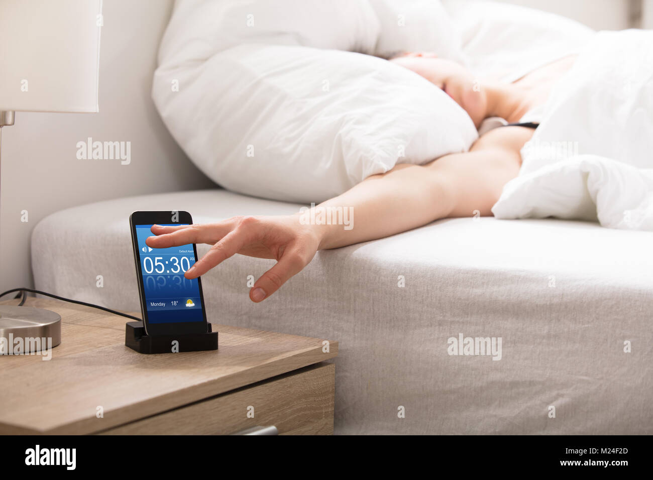 Woman Sleeping On Bed Snoozing Alarm On Smart Phone Screen Stock Photo ...