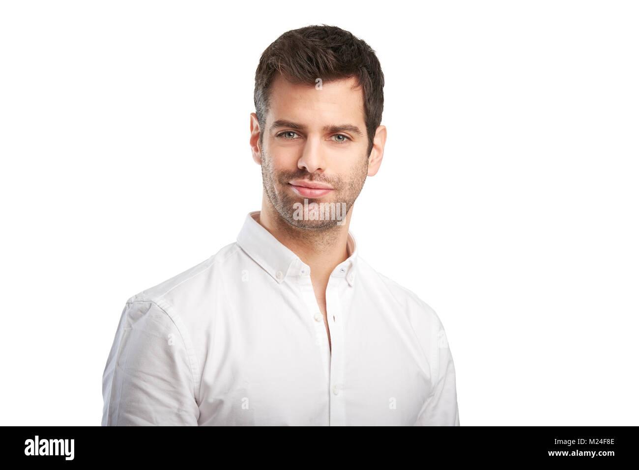 Portrait of smiling young businessman standing at isolated white ...