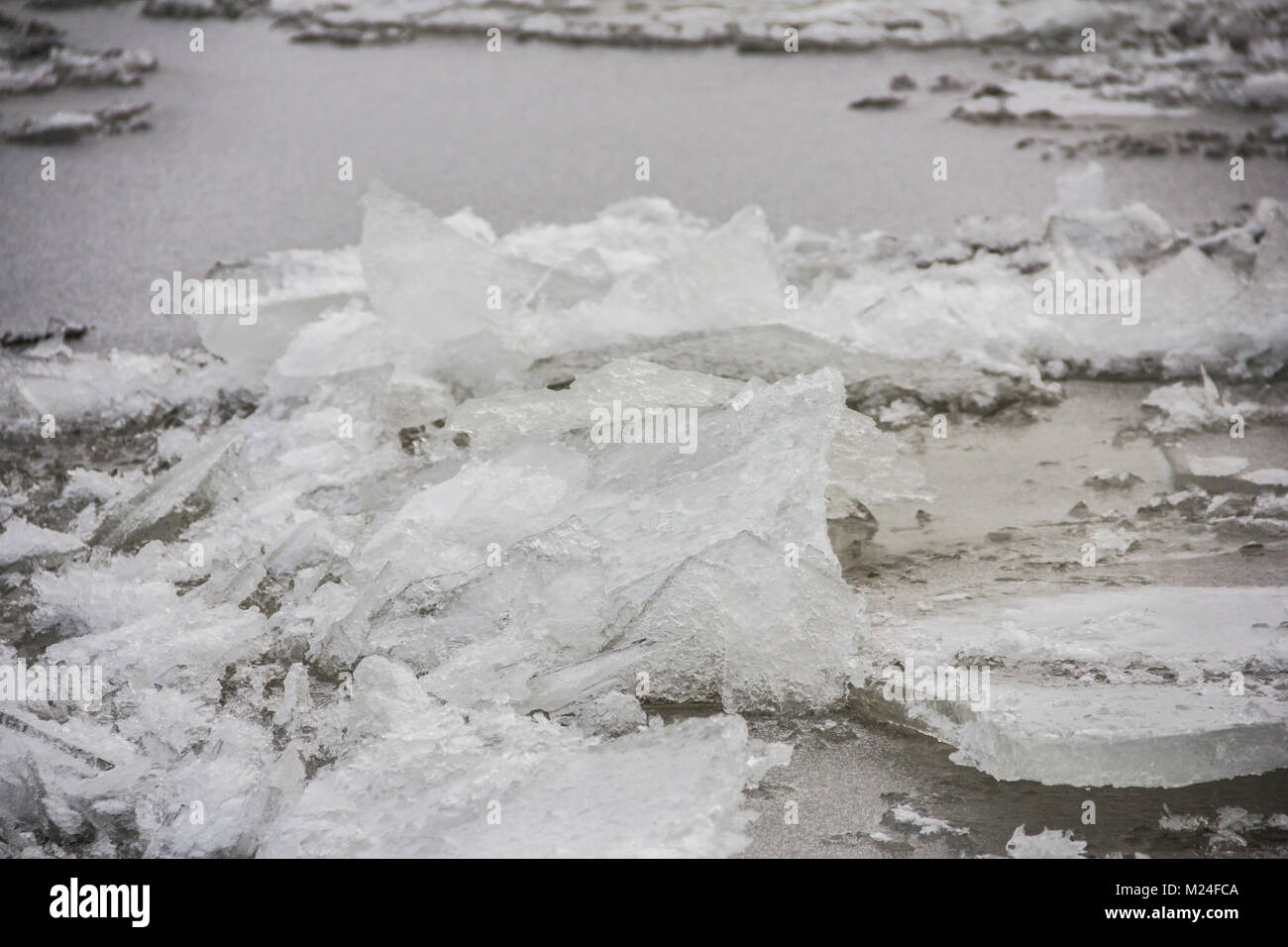 snow covered formed pack ice on the background of winter river water ...