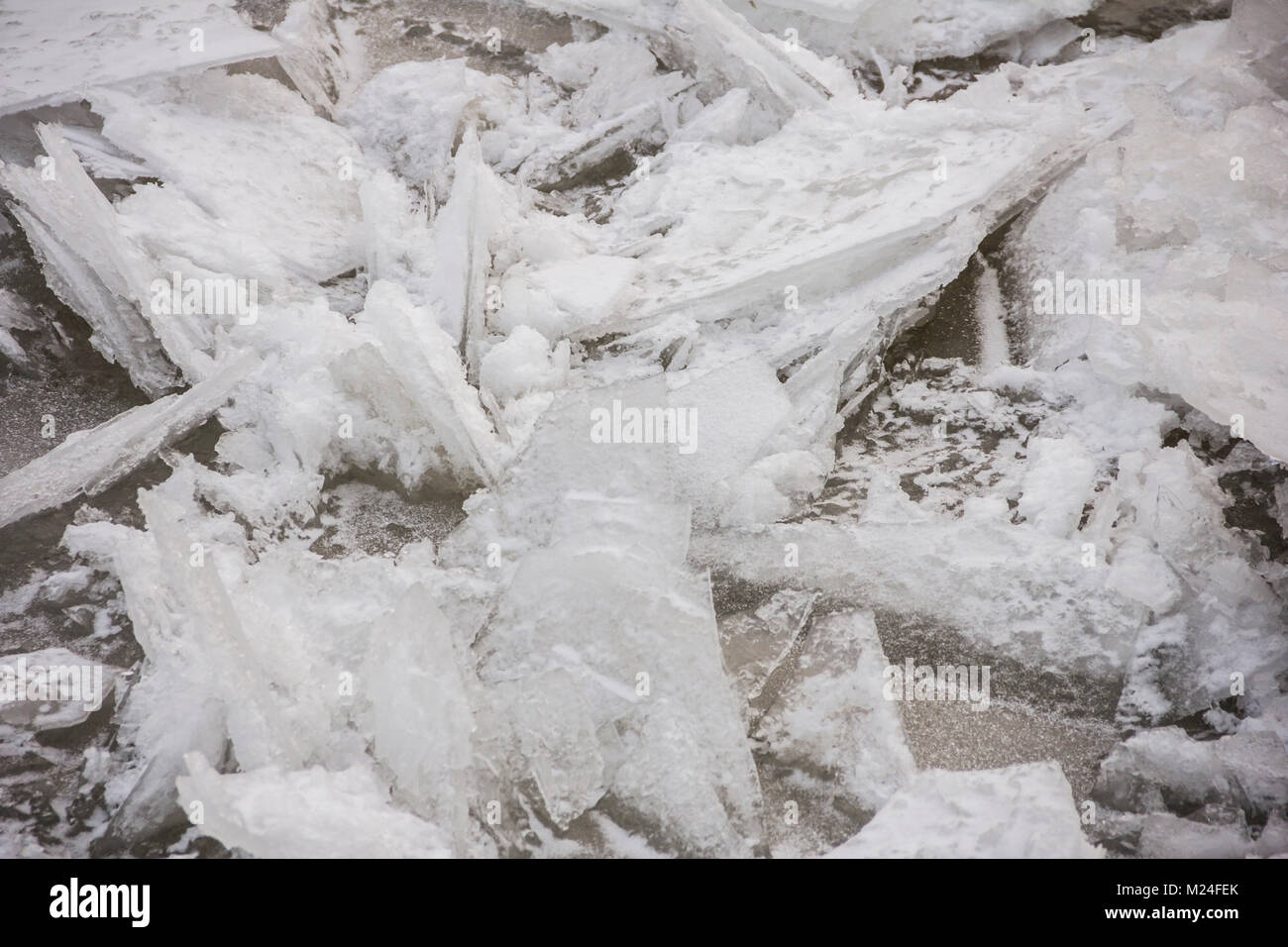 snow covered formed pack ice on the background of winter river water ...