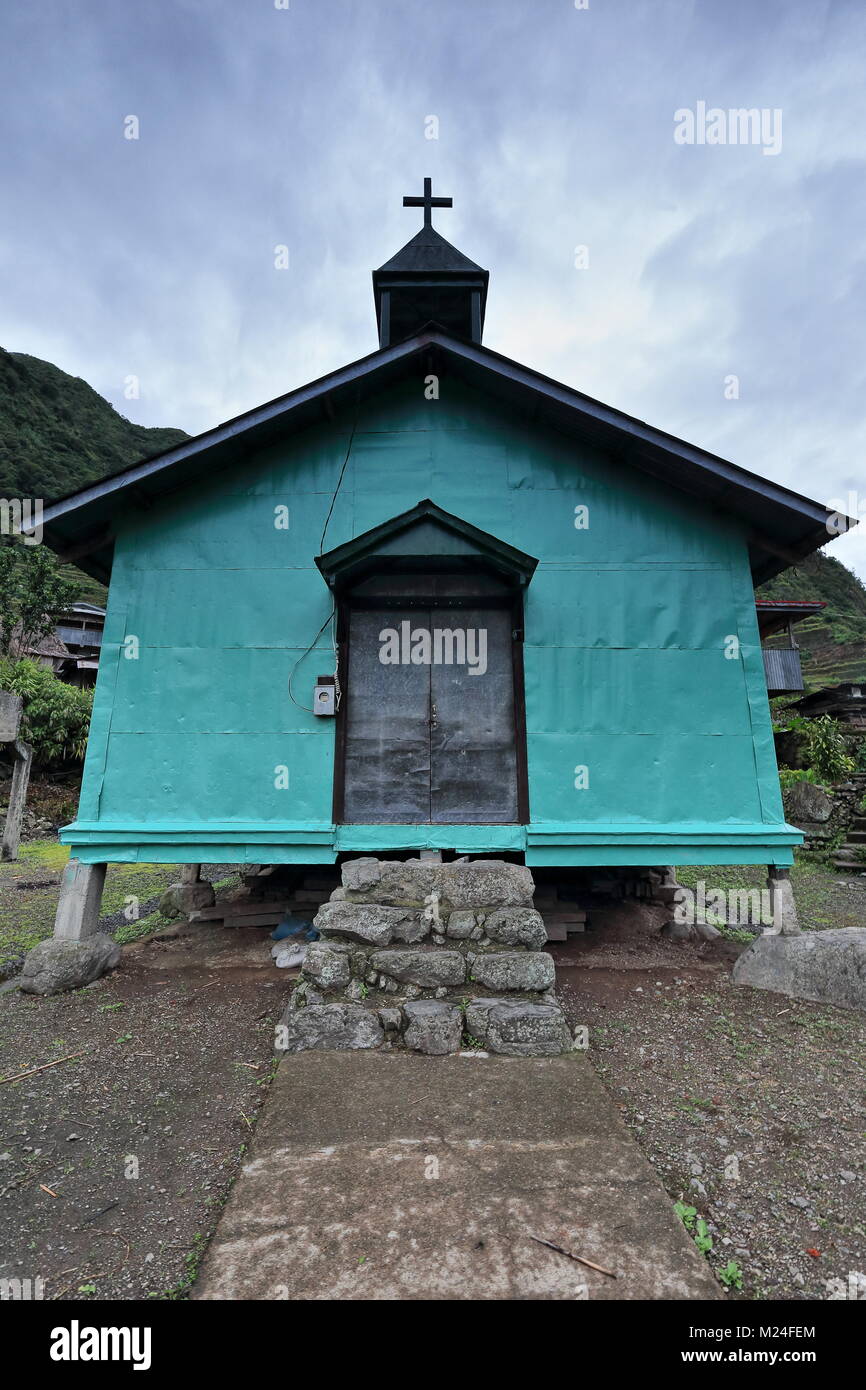 Small green-blue painted chapel made of steel sheet like many houses in ...