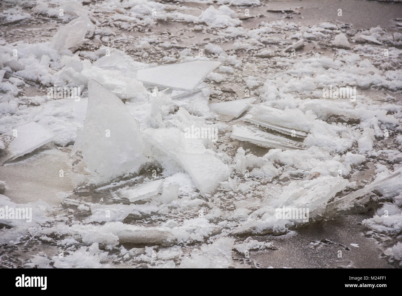 snow covered formed pack ice on the background of winter river water ...