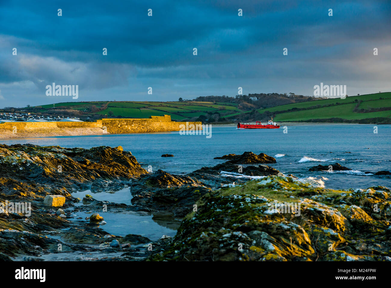 At dawn this bright red ship headed back into the Harbour at Par Docks ...