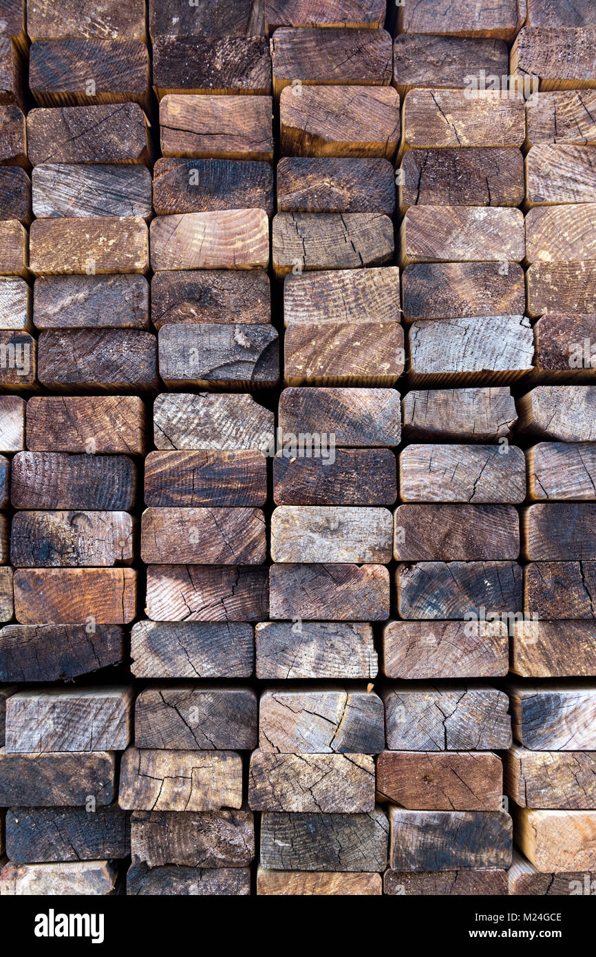 A close-up view of stacked rectangular wooden logs, showcasing the ...