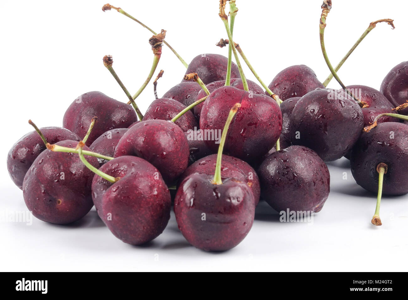 Sweet red cherries isolated on a white background Stock Photo - Alamy