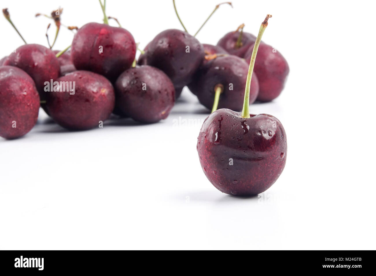 Sweet red cherries isolated on a white background Stock Photo - Alamy