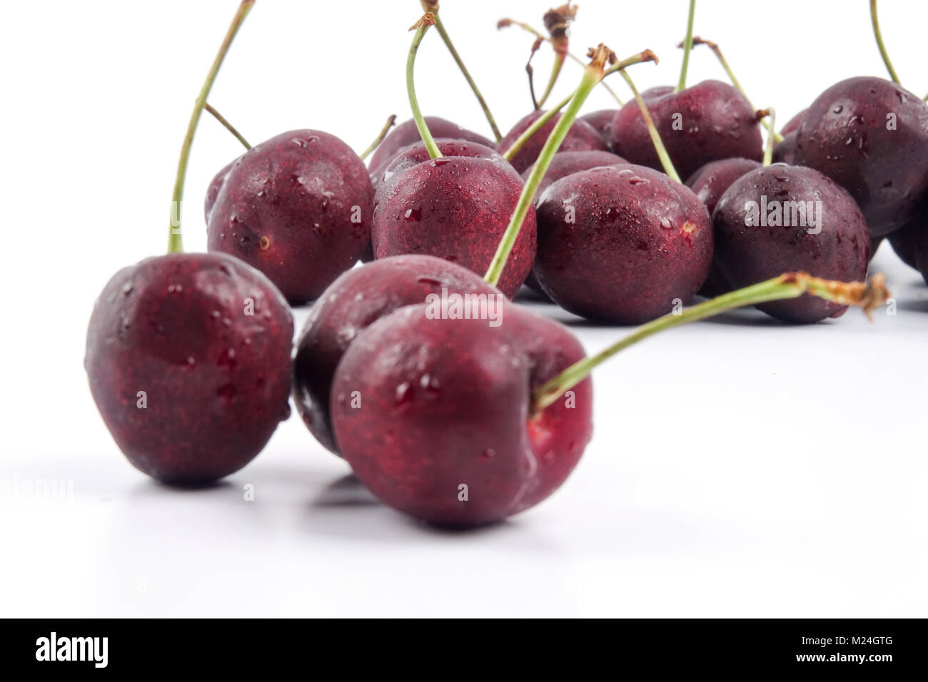 Sweet red cherries isolated on a white background Stock Photo - Alamy