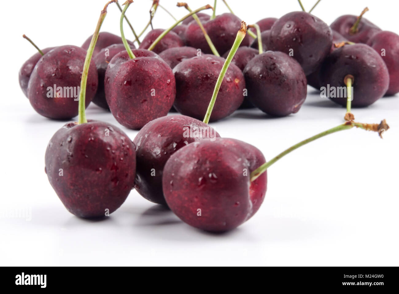 Sweet red cherries isolated on a white background Stock Photo - Alamy