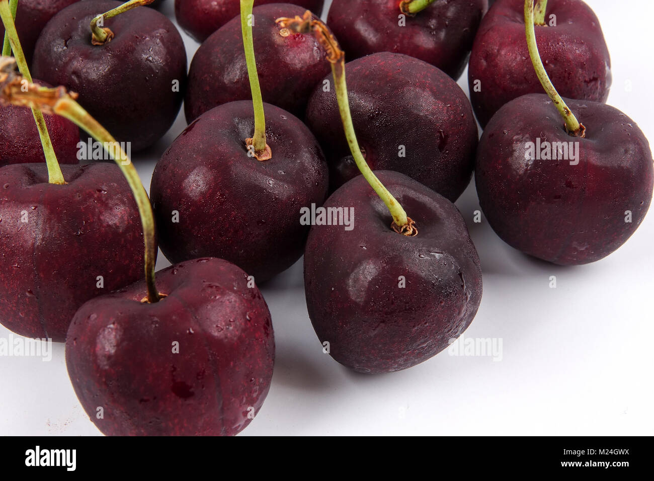 Sweet red cherries isolated on a white background Stock Photo - Alamy