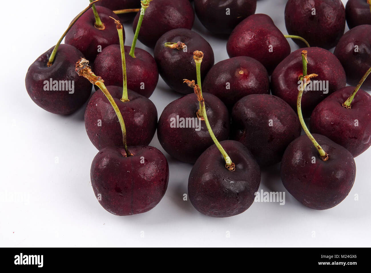 Sweet red cherries isolated on a white background Stock Photo - Alamy