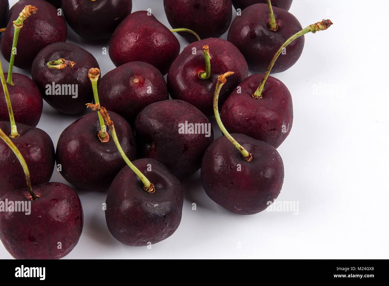 Sweet red cherries isolated on a white background Stock Photo - Alamy