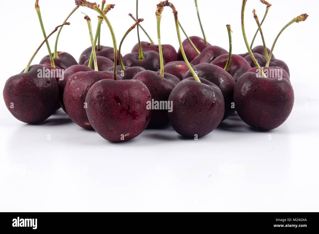 Sweet red cherries isolated on a white background Stock Photo - Alamy