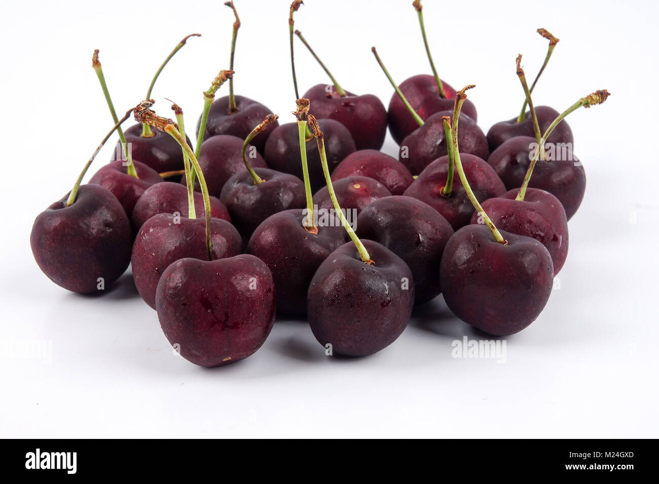 Sweet red cherries isolated on a white background Stock Photo - Alamy