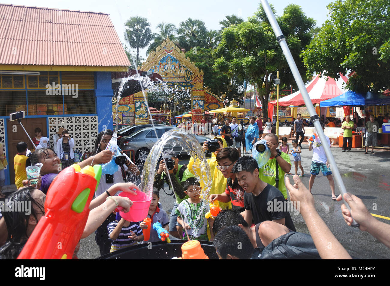 People at the Songkran festival throwing water in buckets at each other ...