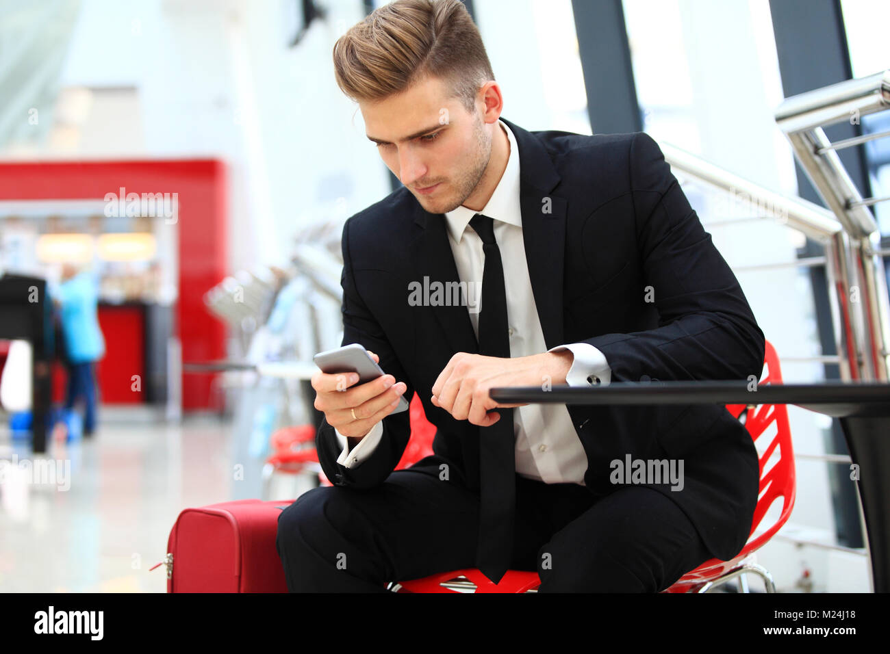 Young attractive business man using smartphone Stock Photo - Alamy