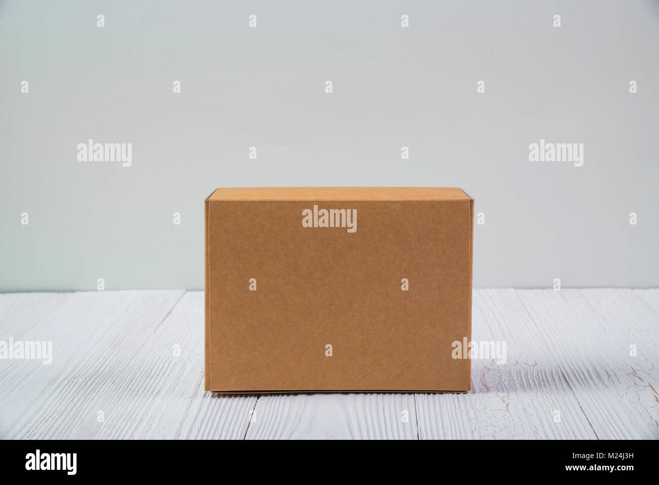 Empty Package brown cardboard box or tray on bright white wooden table ...