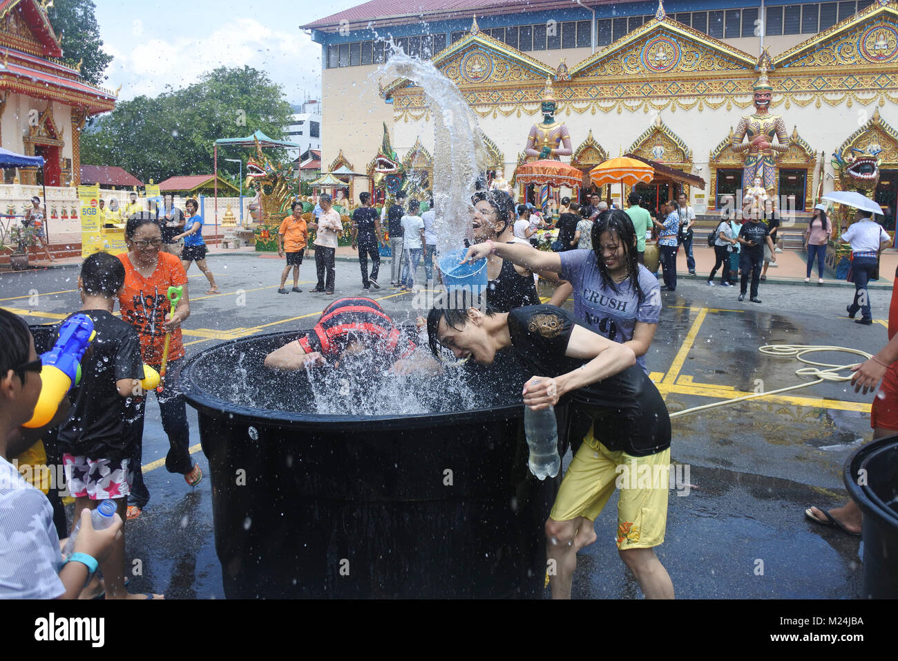 People at the Songkran festival throwing water in buckets at each other ...