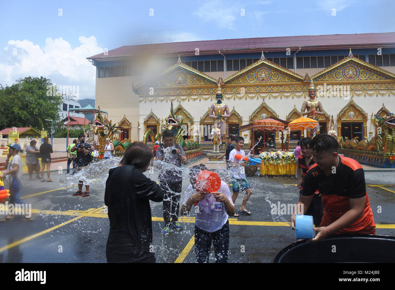 People at the Songkran festival throwing water in buckets at each other ...