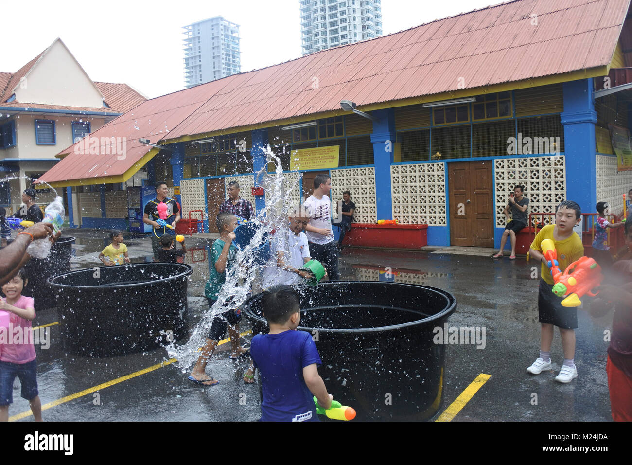 People at the Songkran festival throwing water in buckets at each other ...
