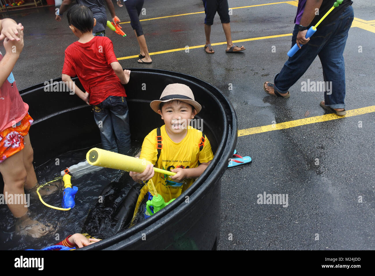 Young child in the mini water tank waiting to soak someone at the ...