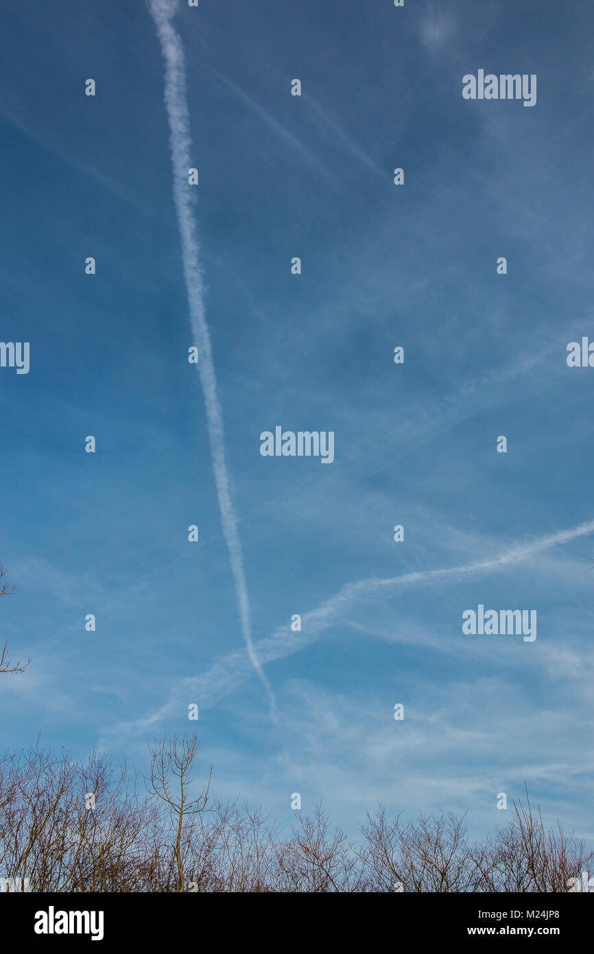 Contrails in the blue sky Stock Photo - Alamy