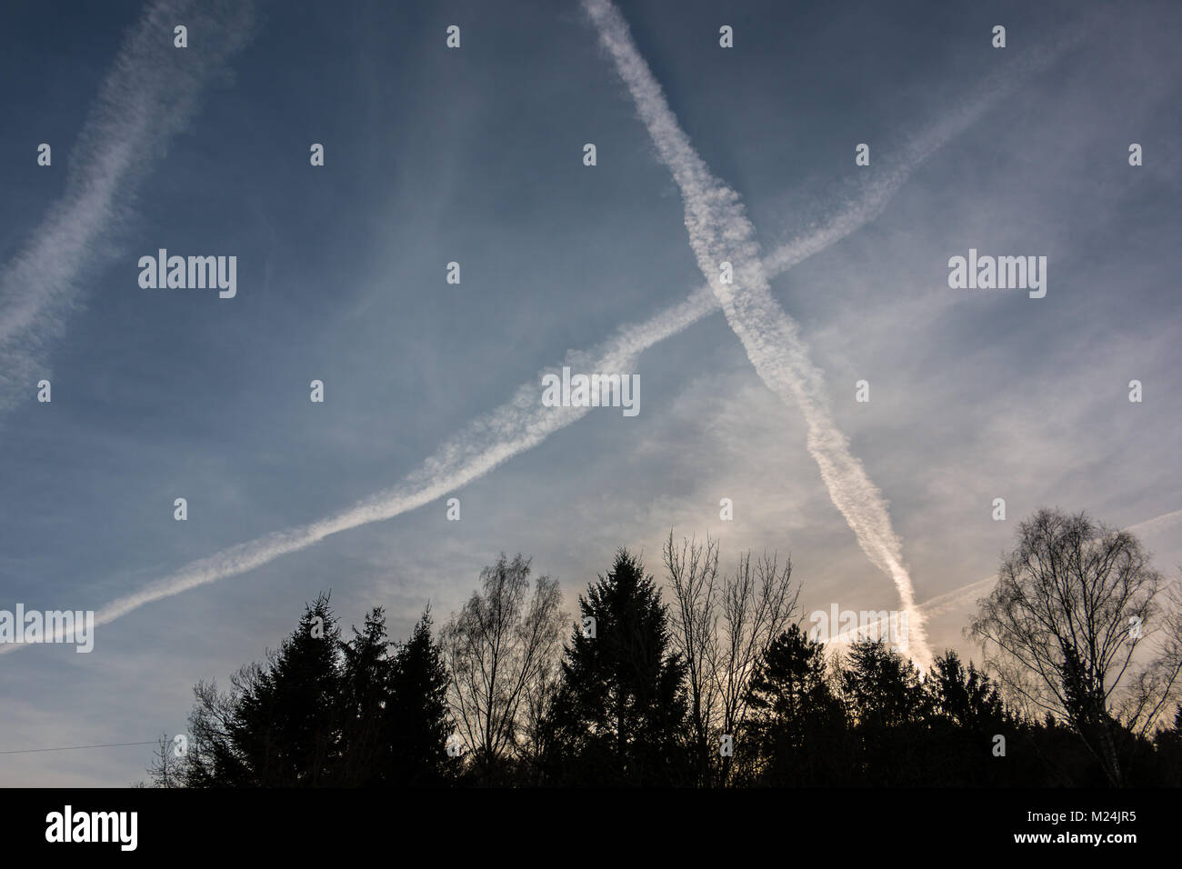 Contrails in the blue sky Stock Photo - Alamy