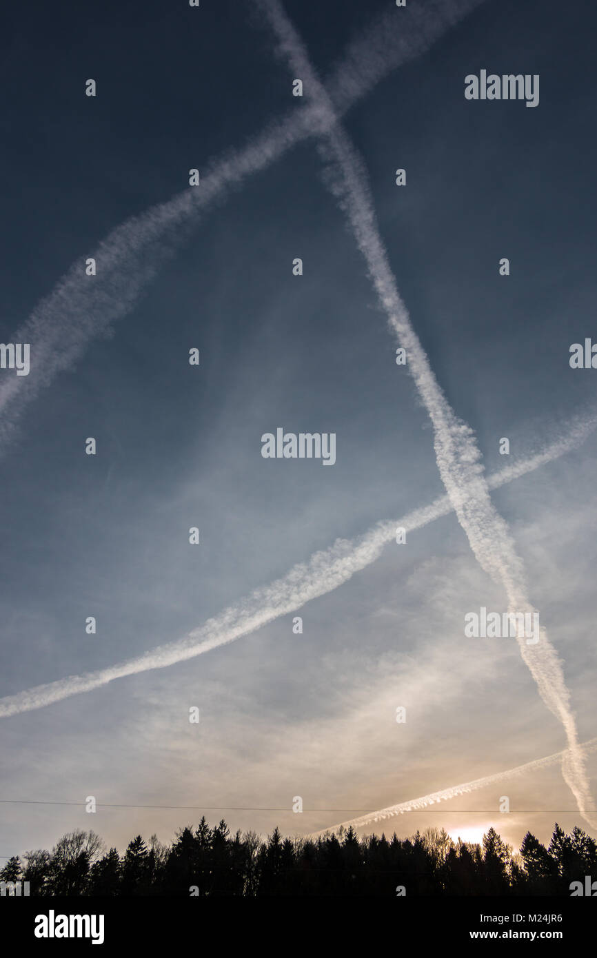 Contrails in the blue sky Stock Photo - Alamy