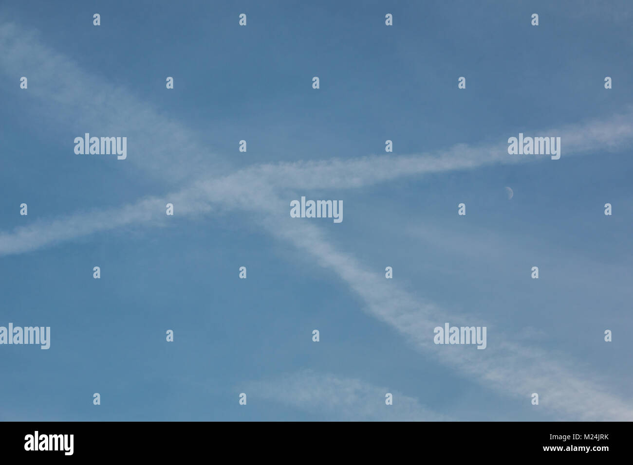 Contrails in the blue sky Stock Photo - Alamy