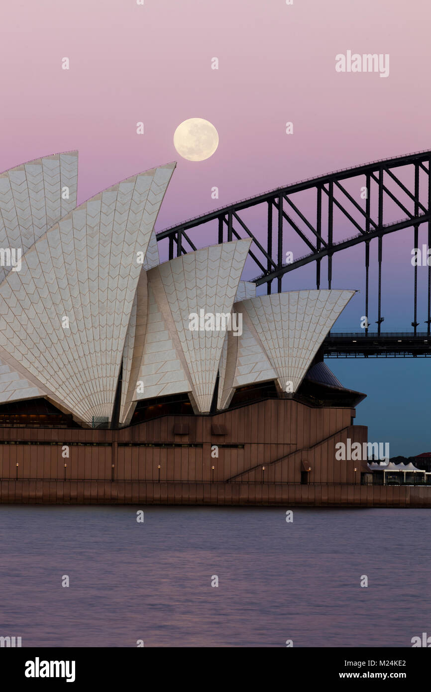 A full moon hovers over the Sydney Harbour Bridge and Opera House. The ...