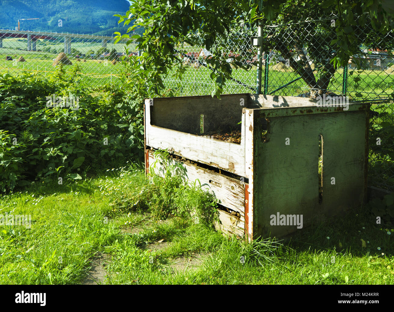 Composting in the garden under the tree Stock Photo - Alamy