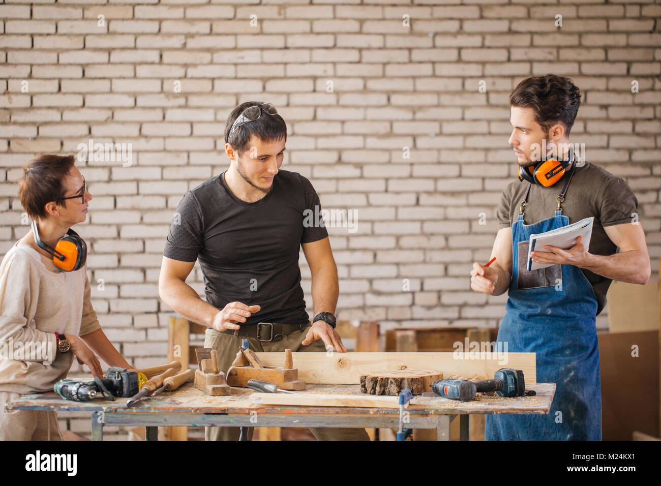 carpenter with students in woodworking workshop Stock Photo - Alamy