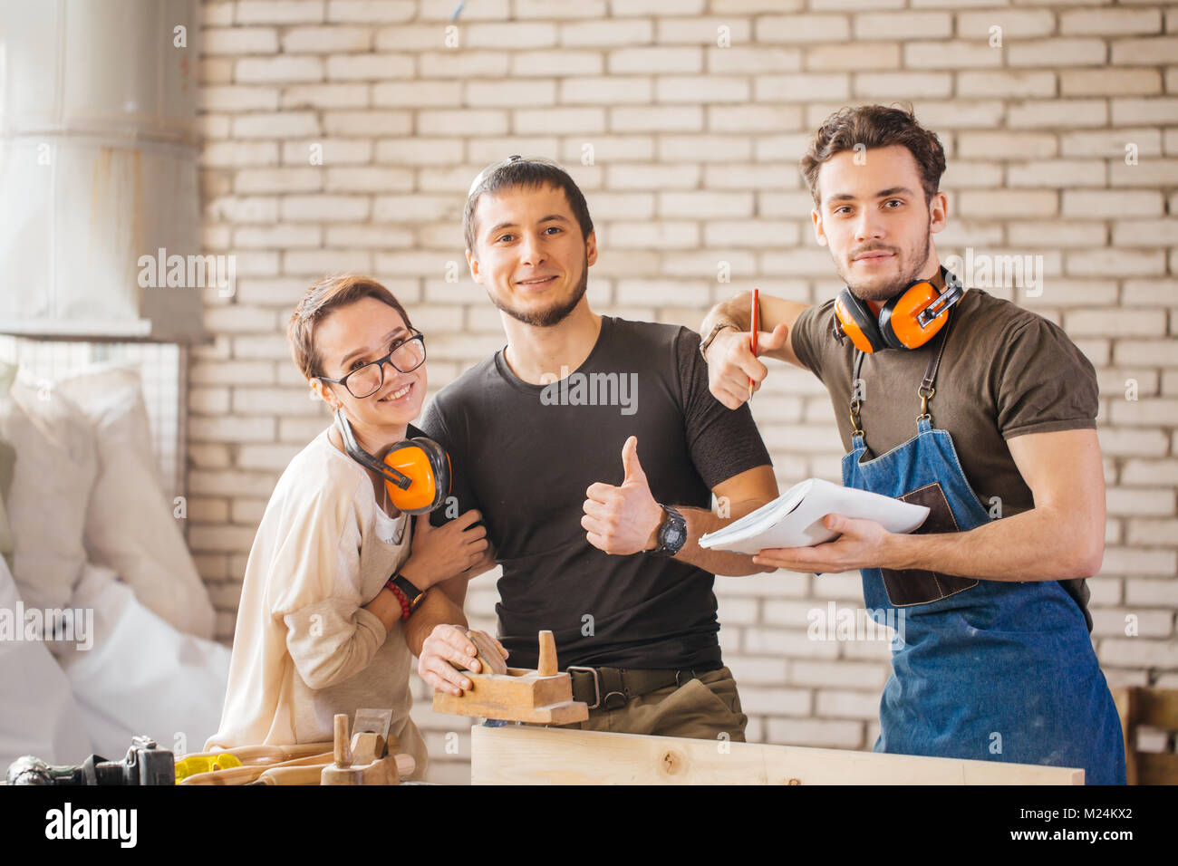 three young craftsmen ready to work Stock Photo - Alamy