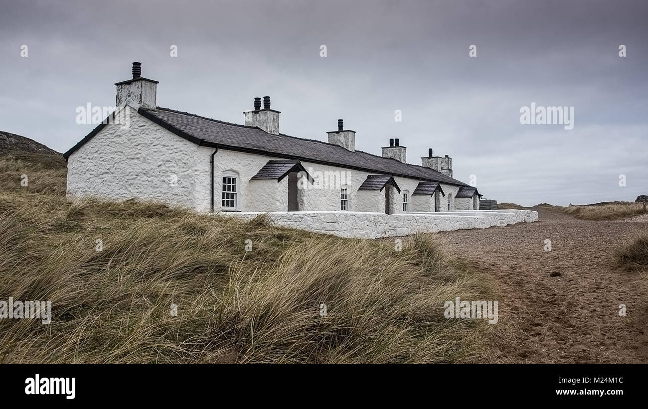 A photograph of a row of old fishermans cottages on the beach in bleak ...