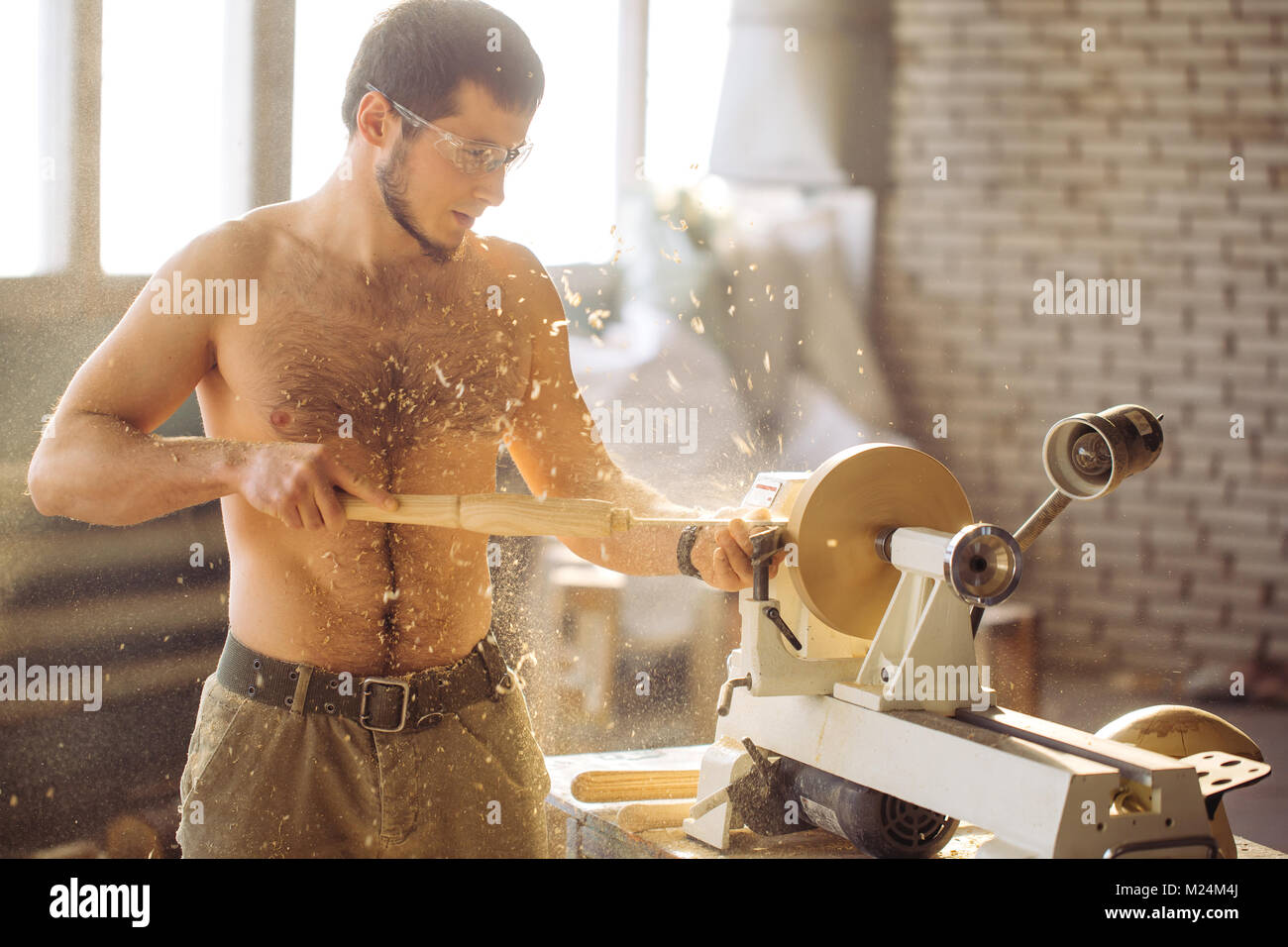 Wood lathe. Carpenter lathing wood Stock Photo - Alamy