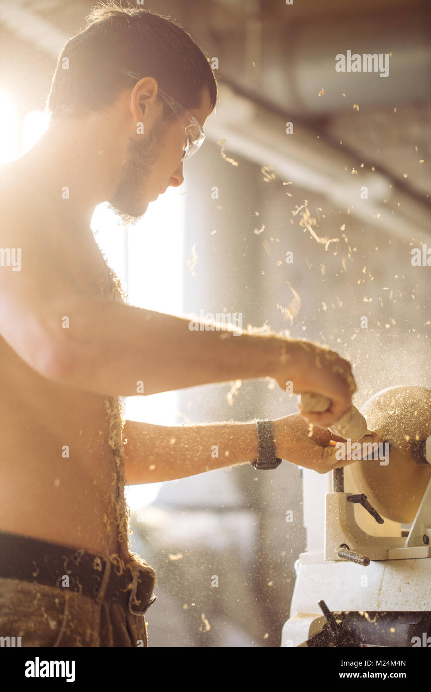 Wood lathe. Carpenter lathing wood Stock Photo - Alamy