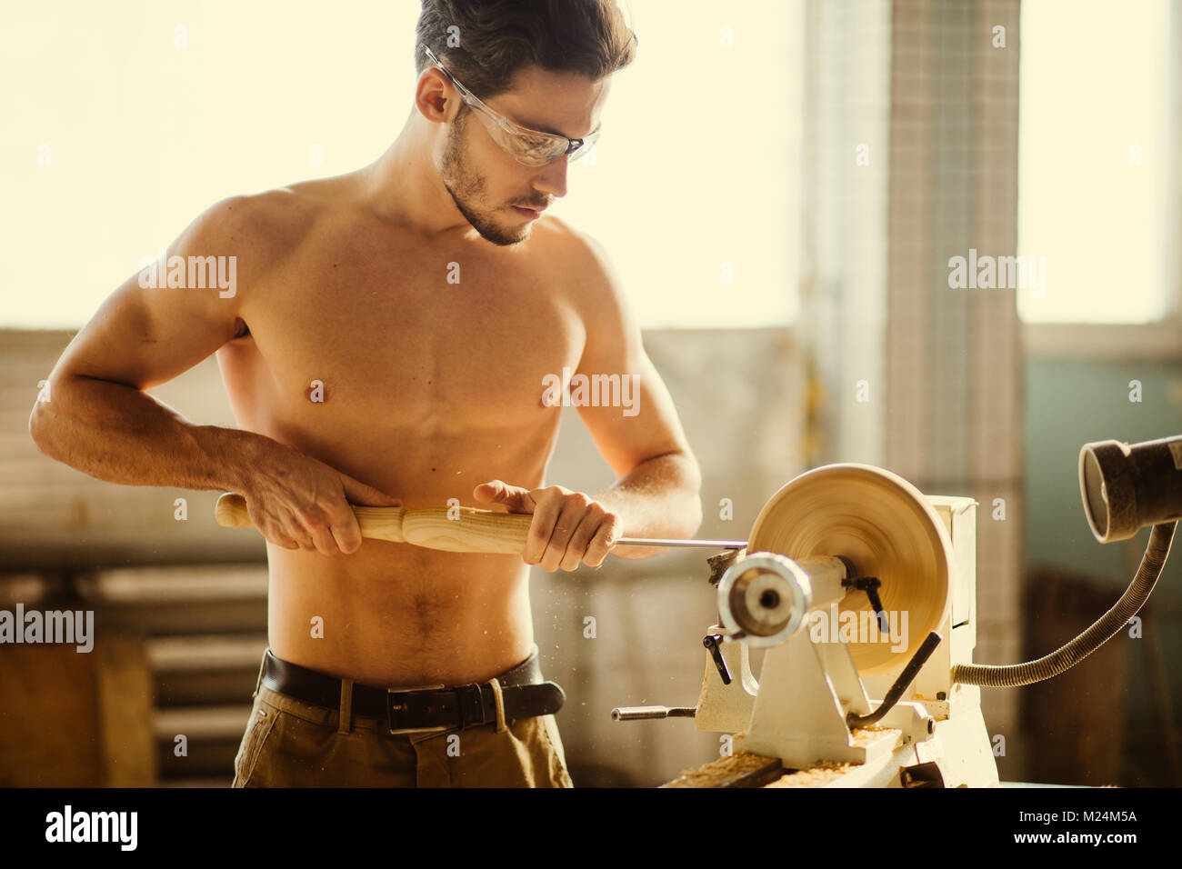 Wood lathe. Carpenter lathing wood Stock Photo - Alamy