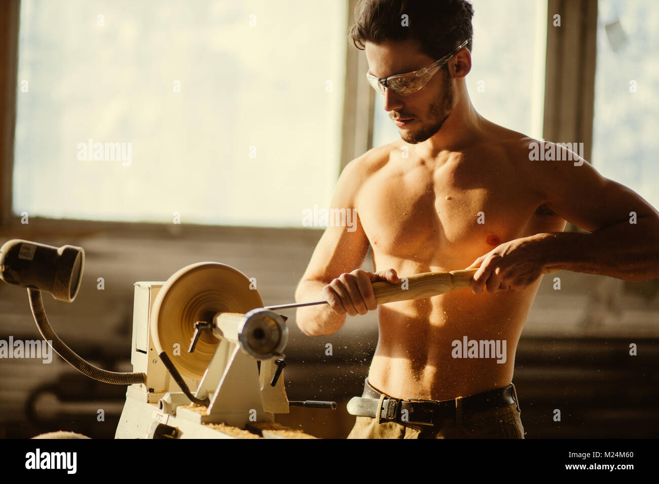 Wood lathe. Carpenter lathing wood Stock Photo - Alamy