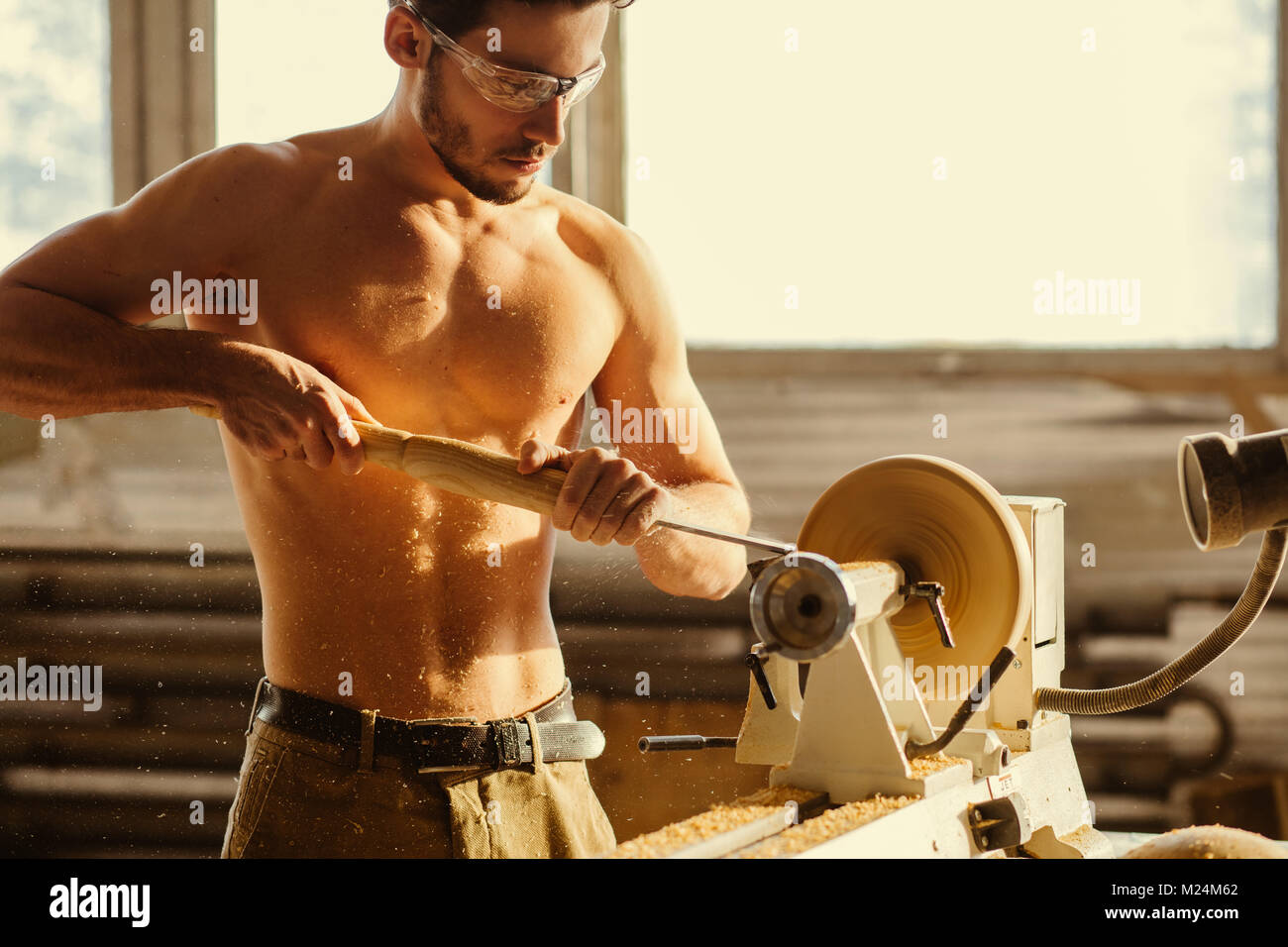 Wood lathe. Carpenter lathing wood Stock Photo - Alamy