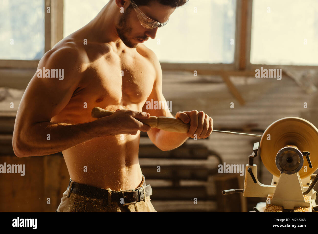 Wood lathe. Carpenter lathing wood Stock Photo - Alamy