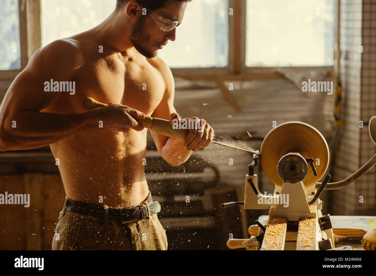 Wood lathe. Carpenter lathing wood Stock Photo - Alamy