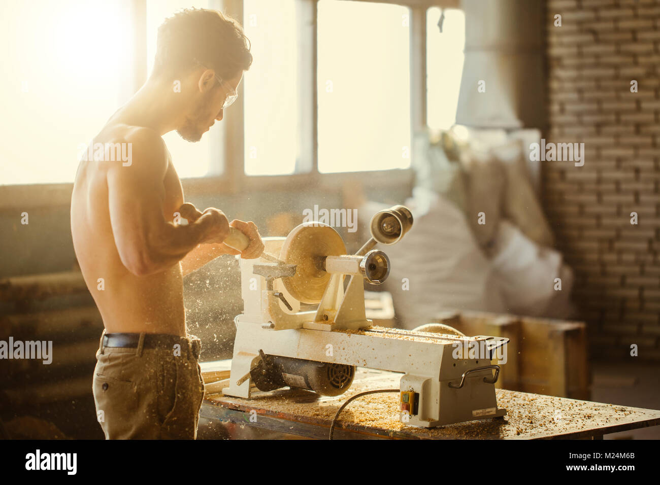 Wood lathe. Carpenter lathing wood Stock Photo - Alamy
