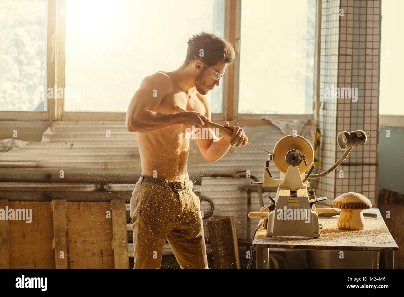 Wood lathe. Carpenter lathing wood Stock Photo - Alamy