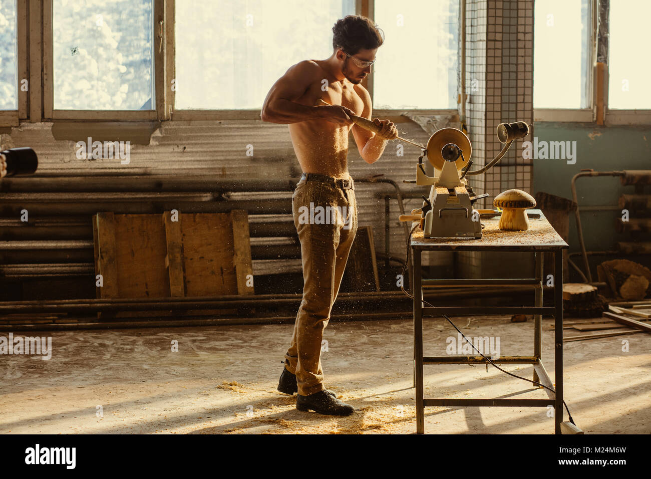 Wood lathe. Carpenter lathing wood Stock Photo - Alamy