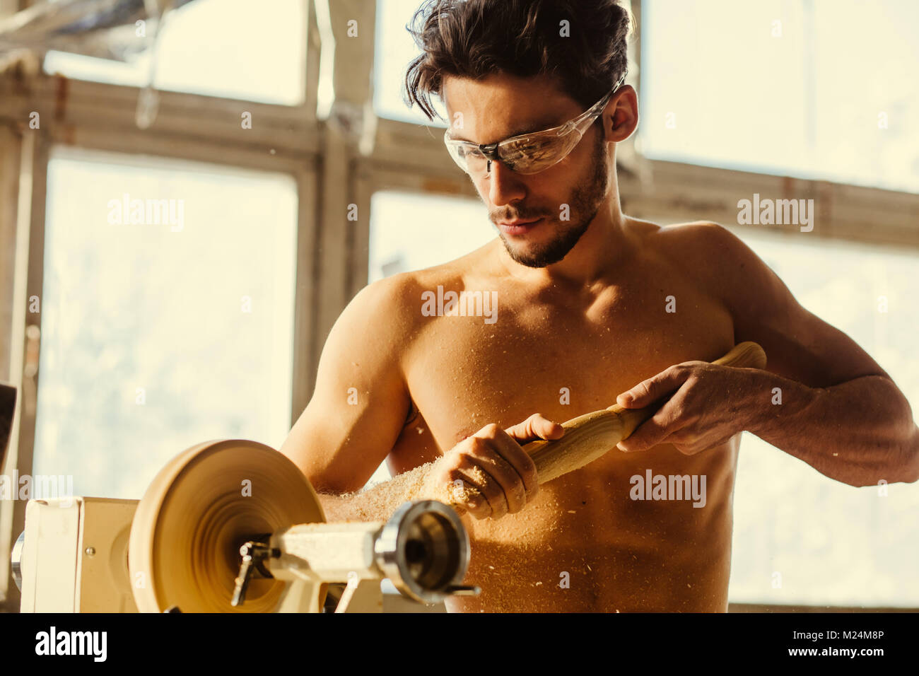 Wood lathe. Carpenter lathing wood Stock Photo - Alamy