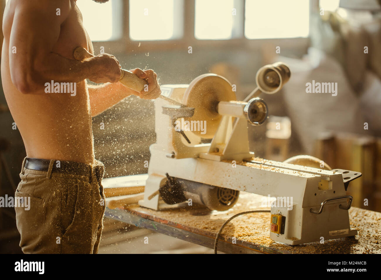 Wood lathe. Carpenter lathing wood Stock Photo - Alamy
