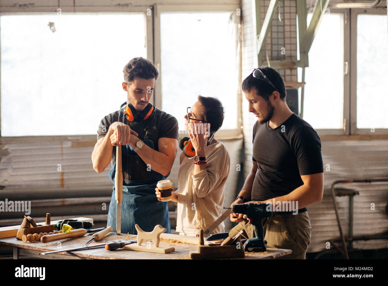 Carpenter Training Female Apprentice To Use Plane Stock Photo - Alamy