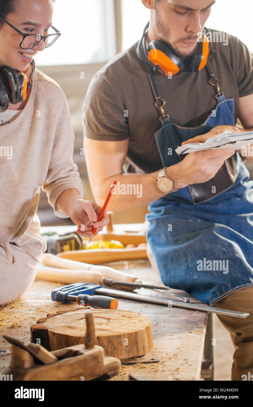 Carpenter Training Female Apprentice To Use Plane Stock Photo - Alamy