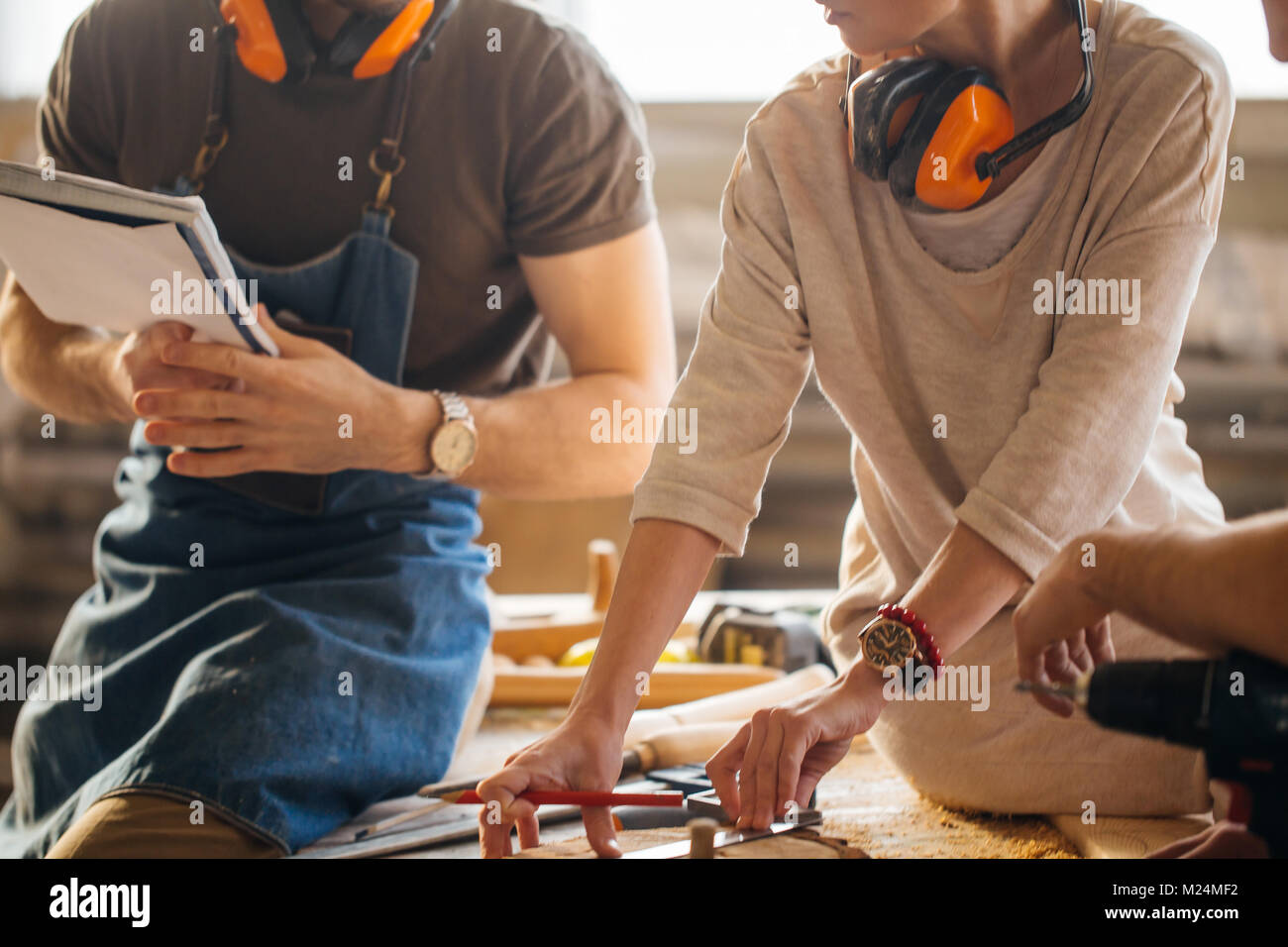 Carpenter Training Female Apprentice To Use Plane Stock Photo - Alamy