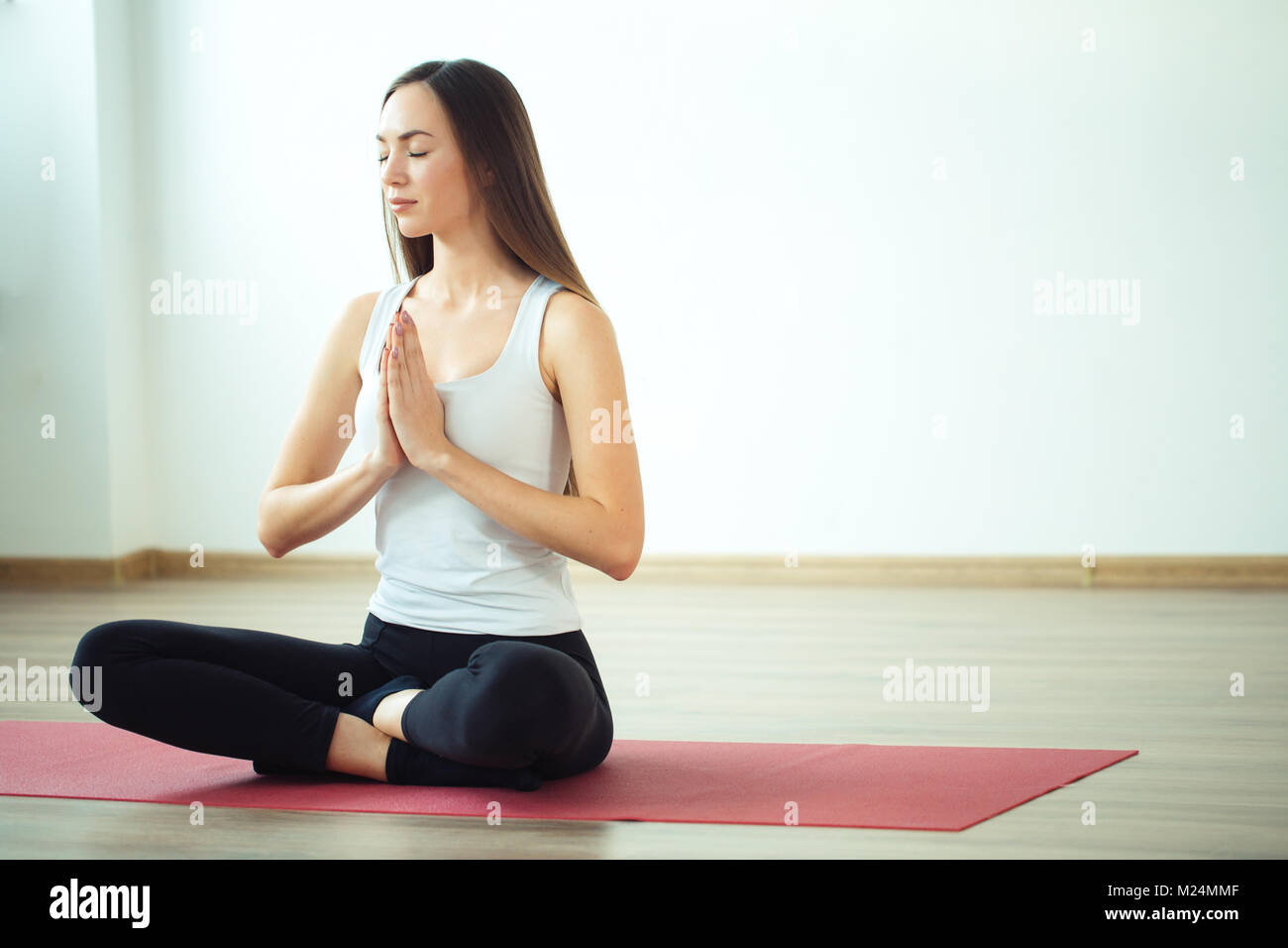 woman practicing yoga, sitting in Padmasana, exercise, Lotus pose ...
